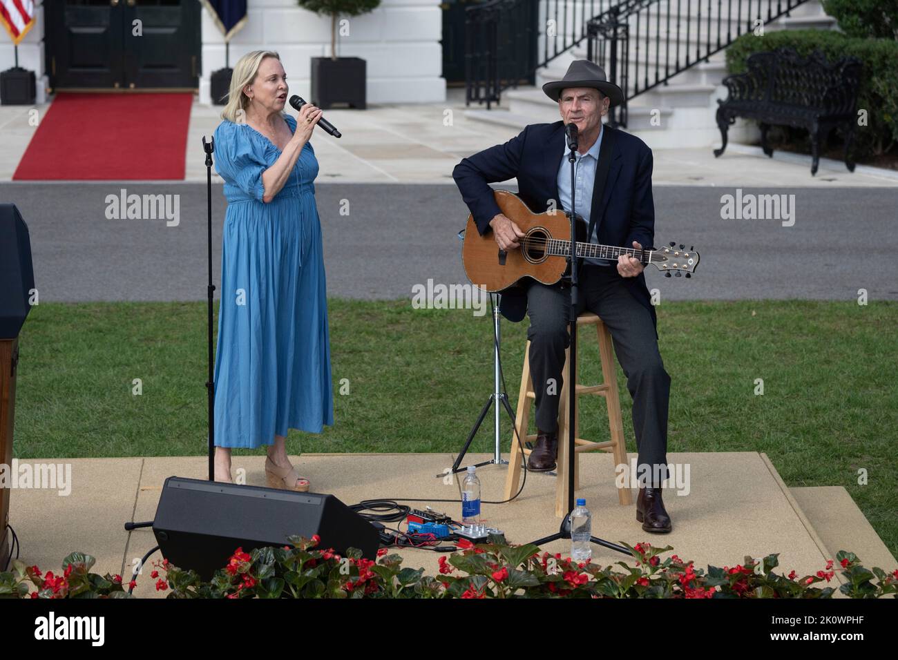 Caroline Smedvig sings with her husband James Taylor at an event ...