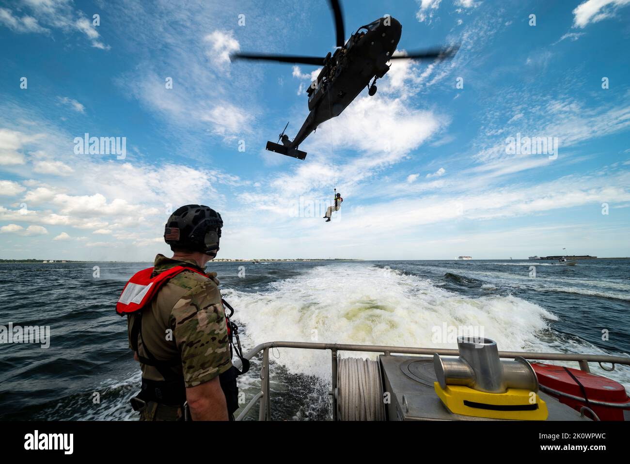 An FBI Hostage Rescue Team member is lowered from a H-60M Black Hawk ...