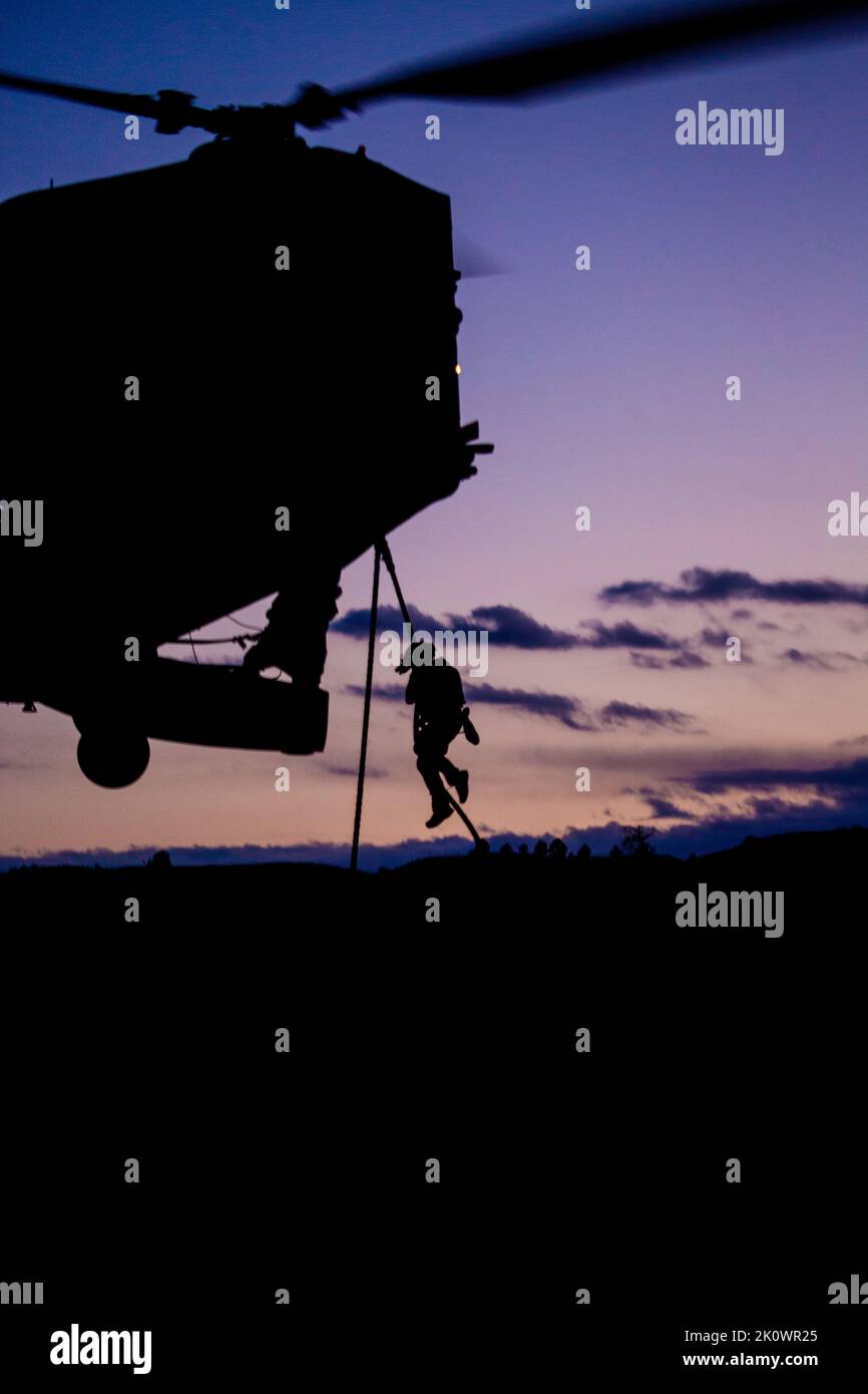 U.S. Army 10th Special Forces Group (Airborne) Operator fast ropes down ...