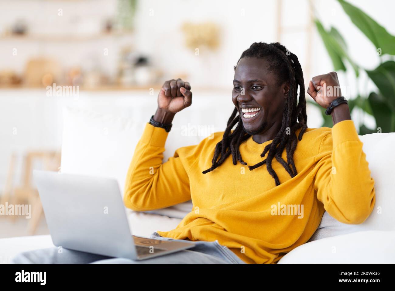 African man celebrating online win hi-res stock photography and images ...