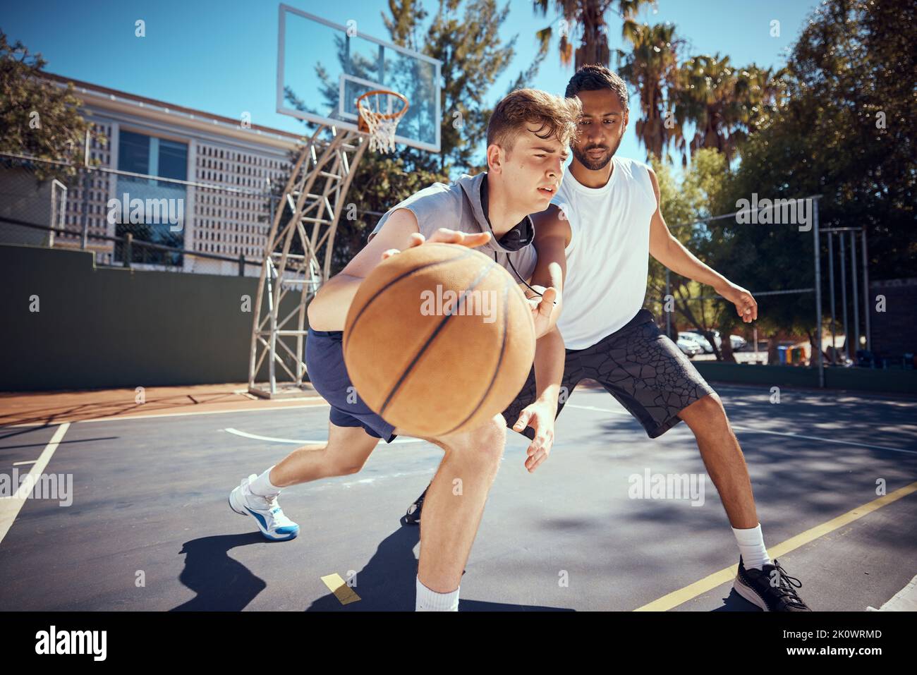 Two male friends playing basketball hi-res stock photography and images ...