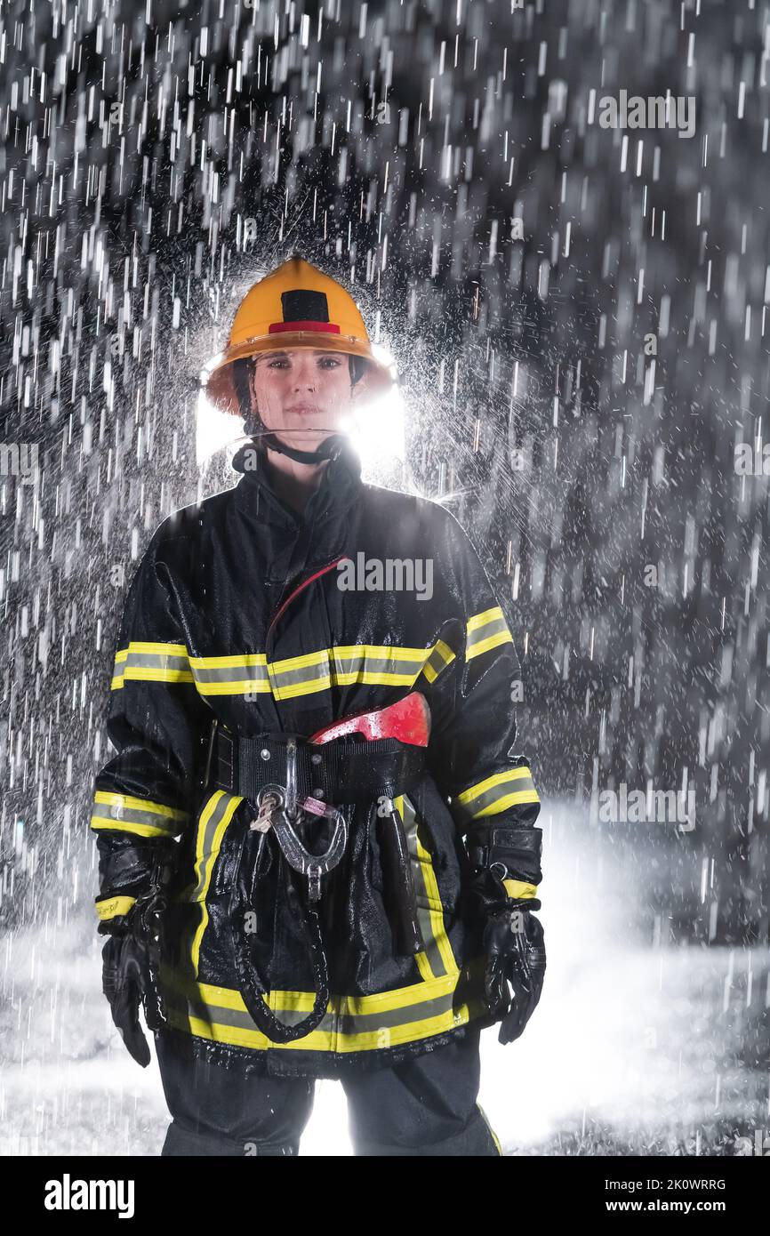 Portrait of a female firefighter standing and walking brave and ...
