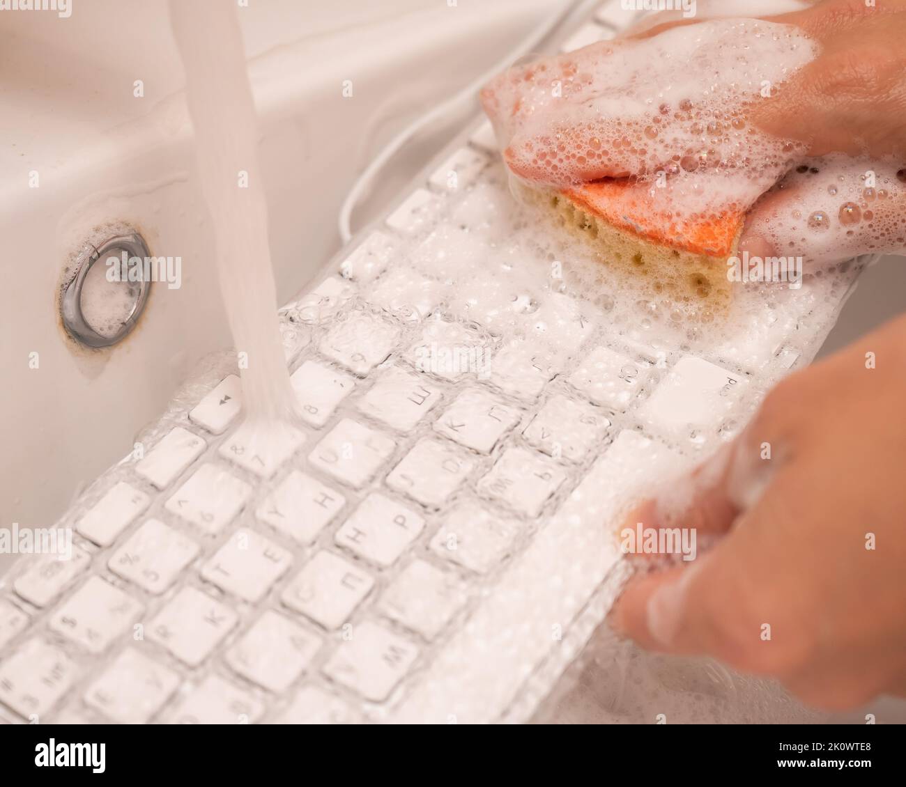 Woman washing white computer keyboard hi-res stock photography and ...
