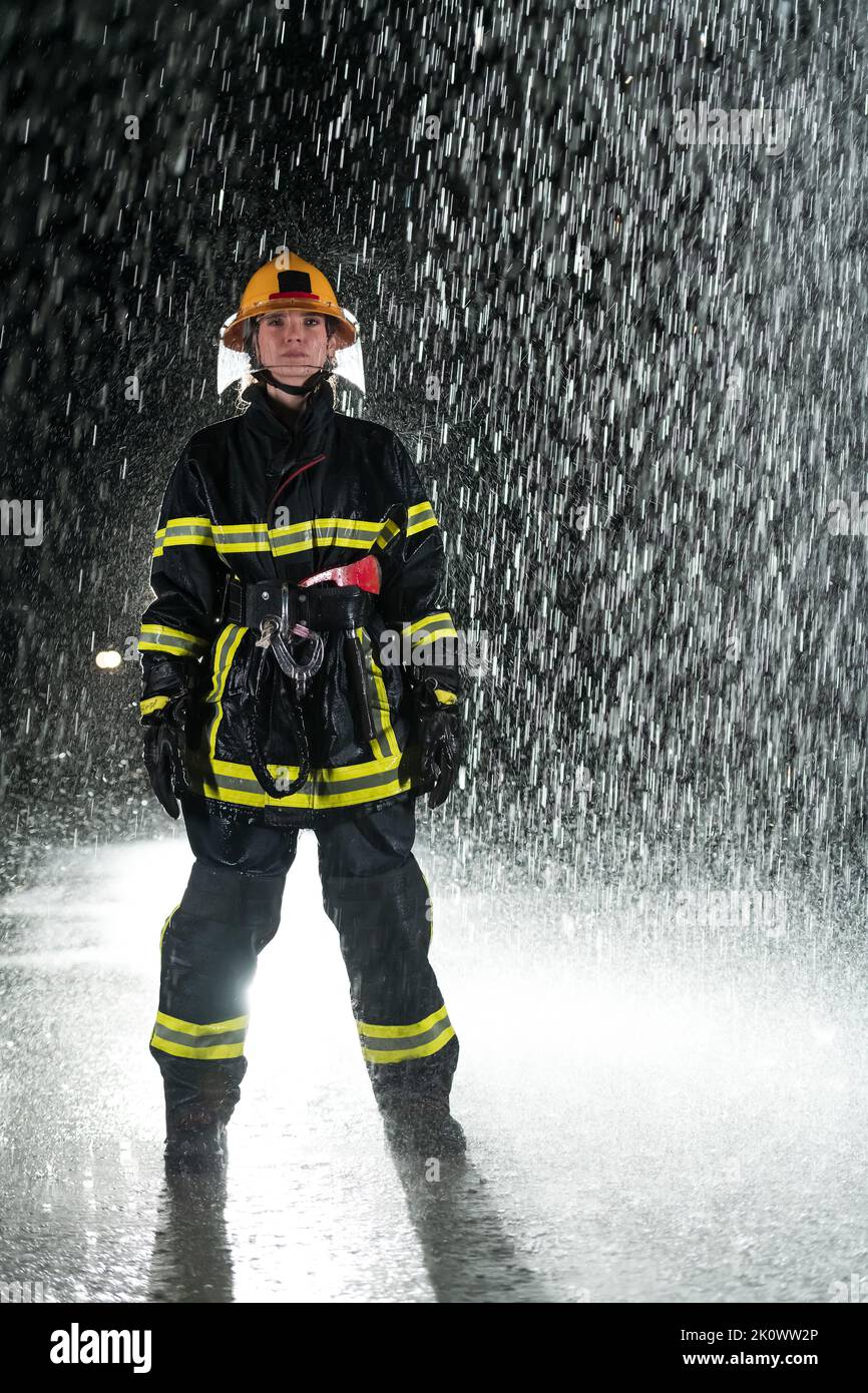 Portrait of a female firefighter standing and walking brave and ...