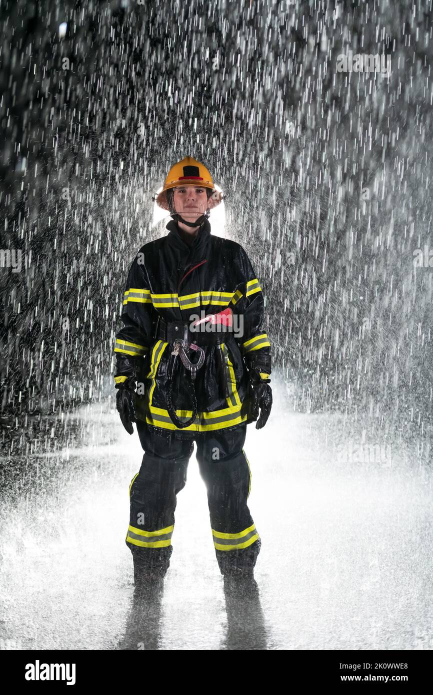 Portrait of a female firefighter standing and walking brave and ...