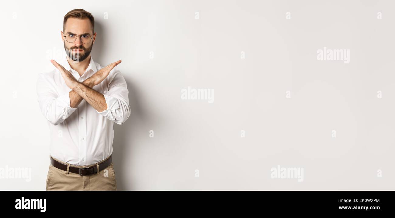 Angry businessman frowning and showing cross, stop you, telling no and ...