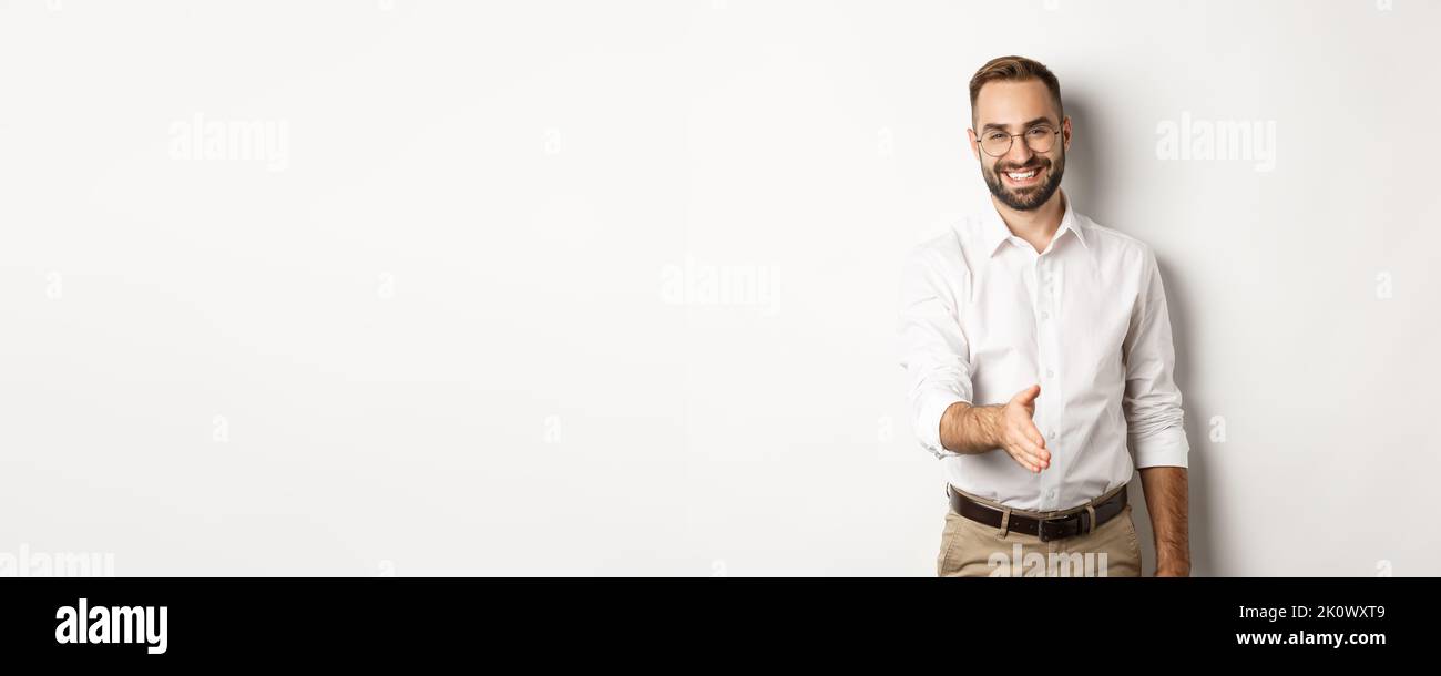 Confident businessman extending hand for handshake, greeting business ...
