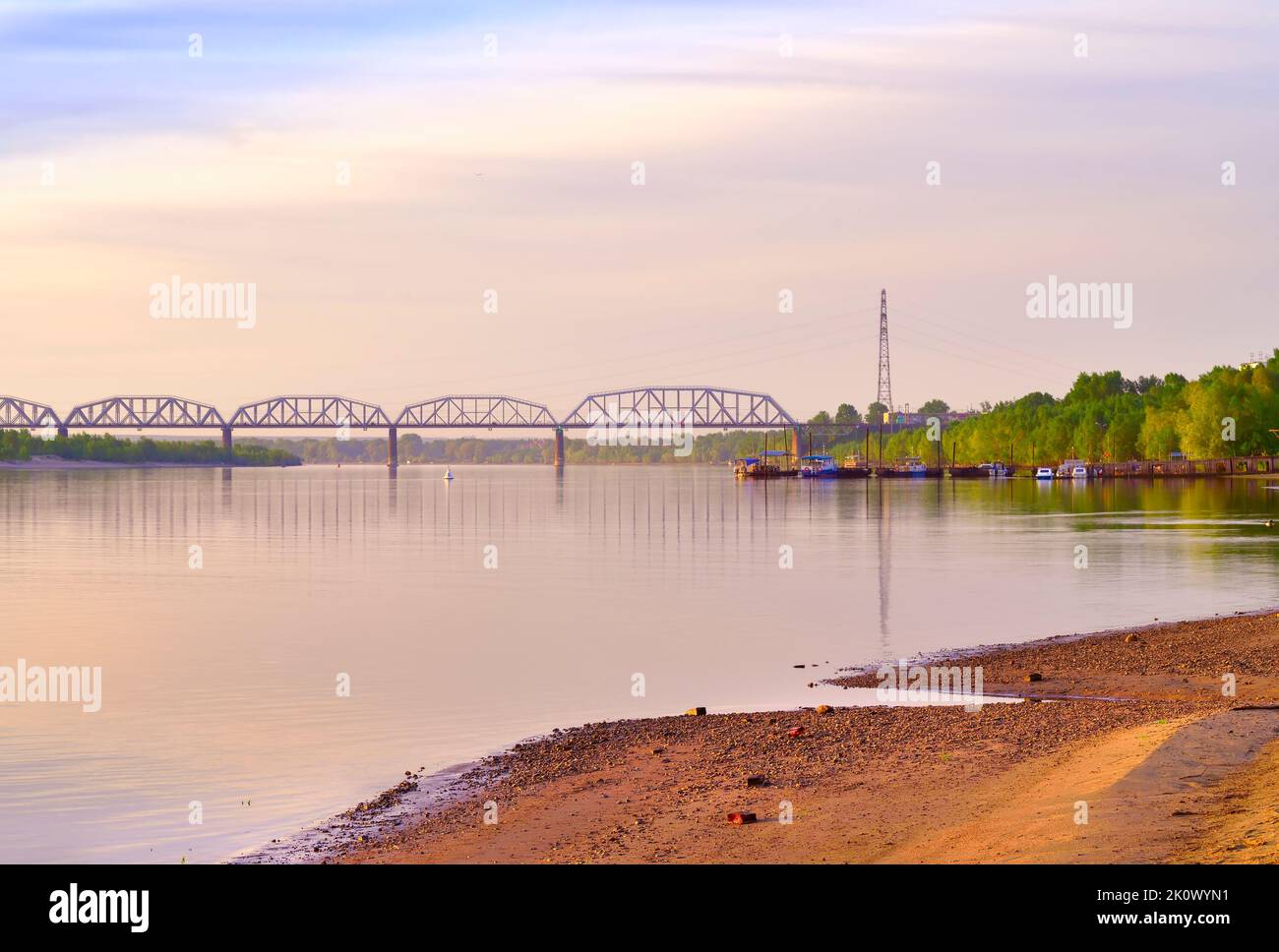 The Ob River at dawn. Sandy beach, railway bridge of the Trans-Siberian ...