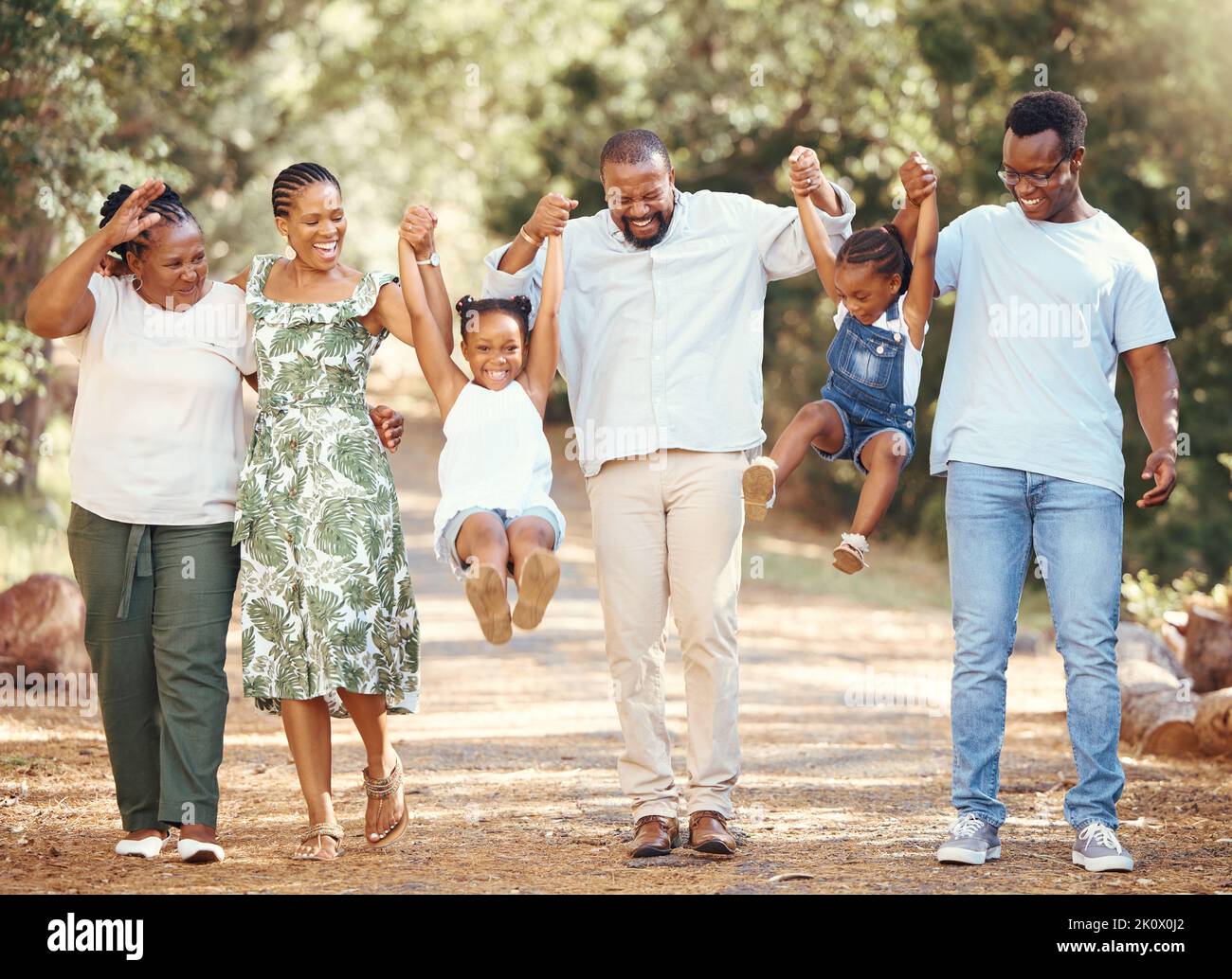 Happy black family bonding and having fun at a park together, laughing ...