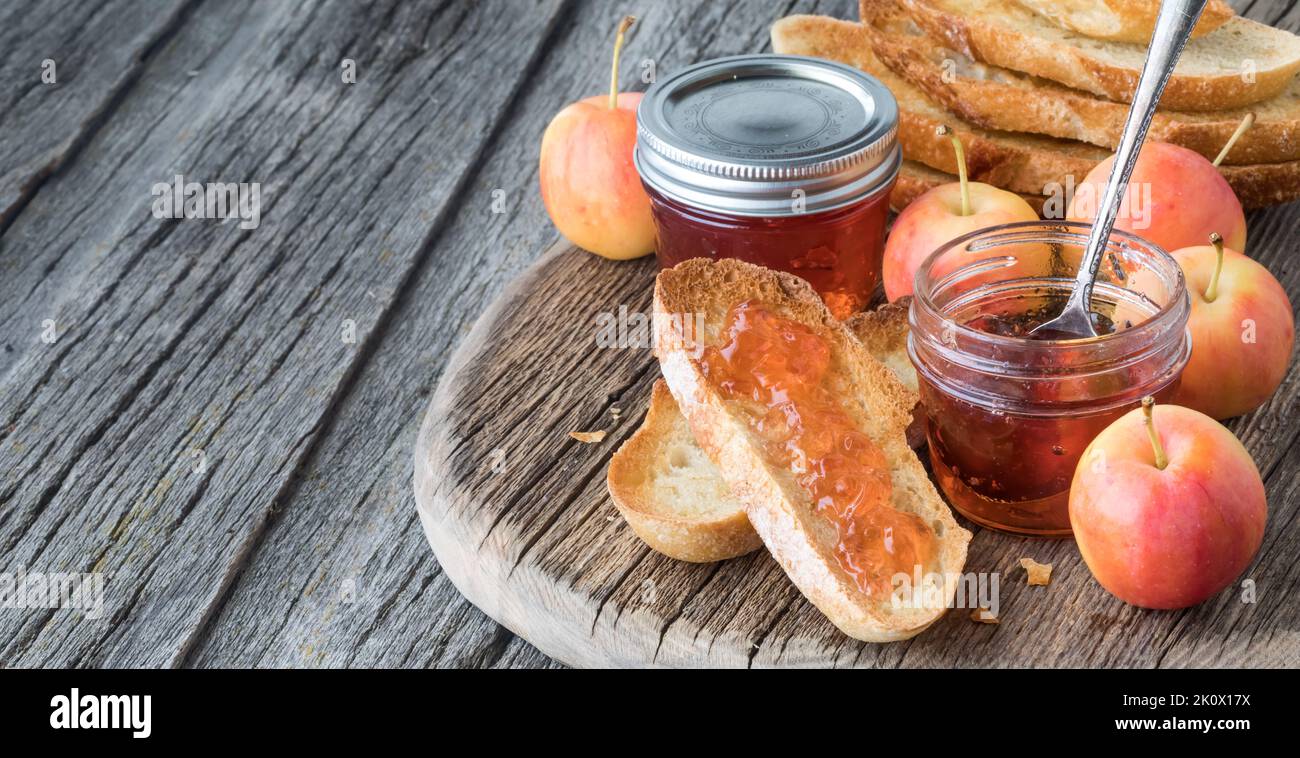 An arrangement of toast and crab apple jelly on a rustic board with ...