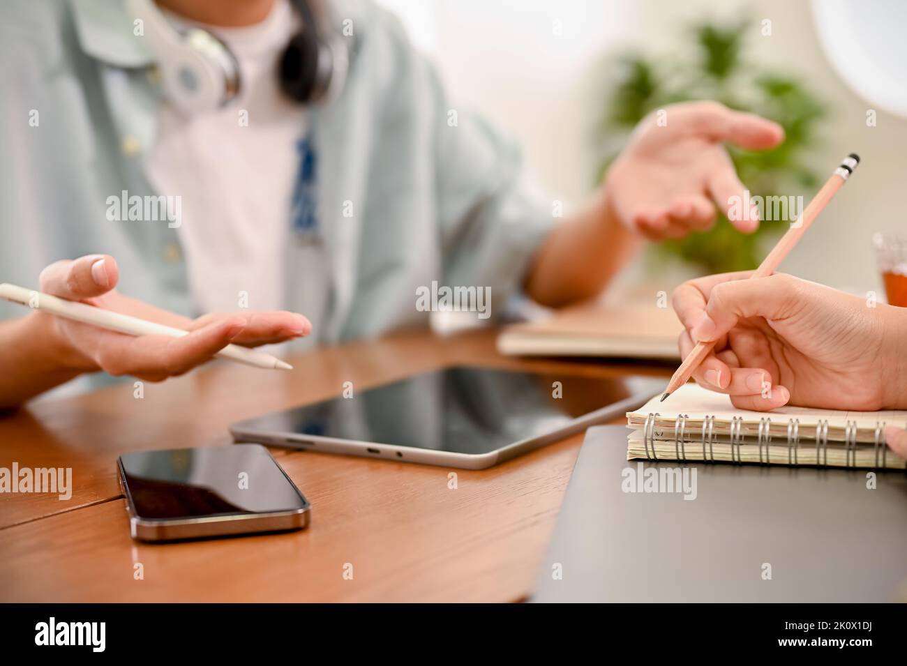 A smart Asian male college student sharing his idea to his friends ...