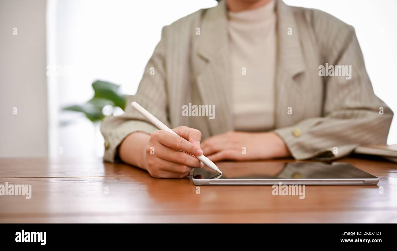 A professional female boss or manager in a formal suit, working at her ...