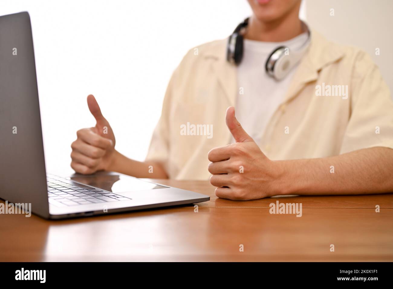 A smart young Asian male office worker or college student looks at his ...