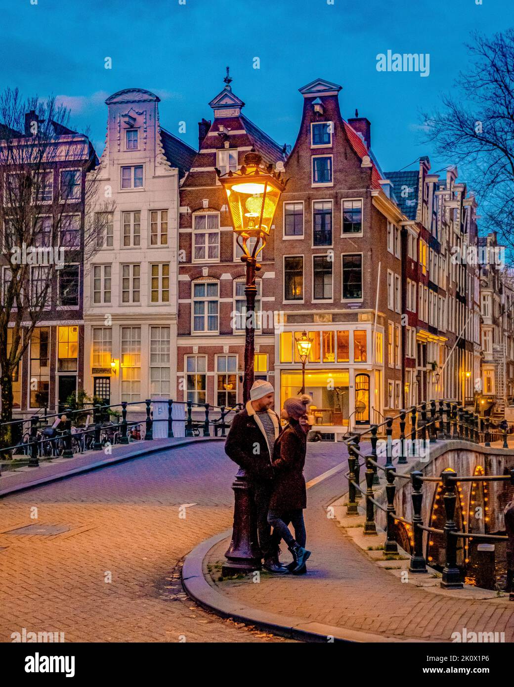 Amsterdam at night couple men and women on a city trip in Amsterdam ...