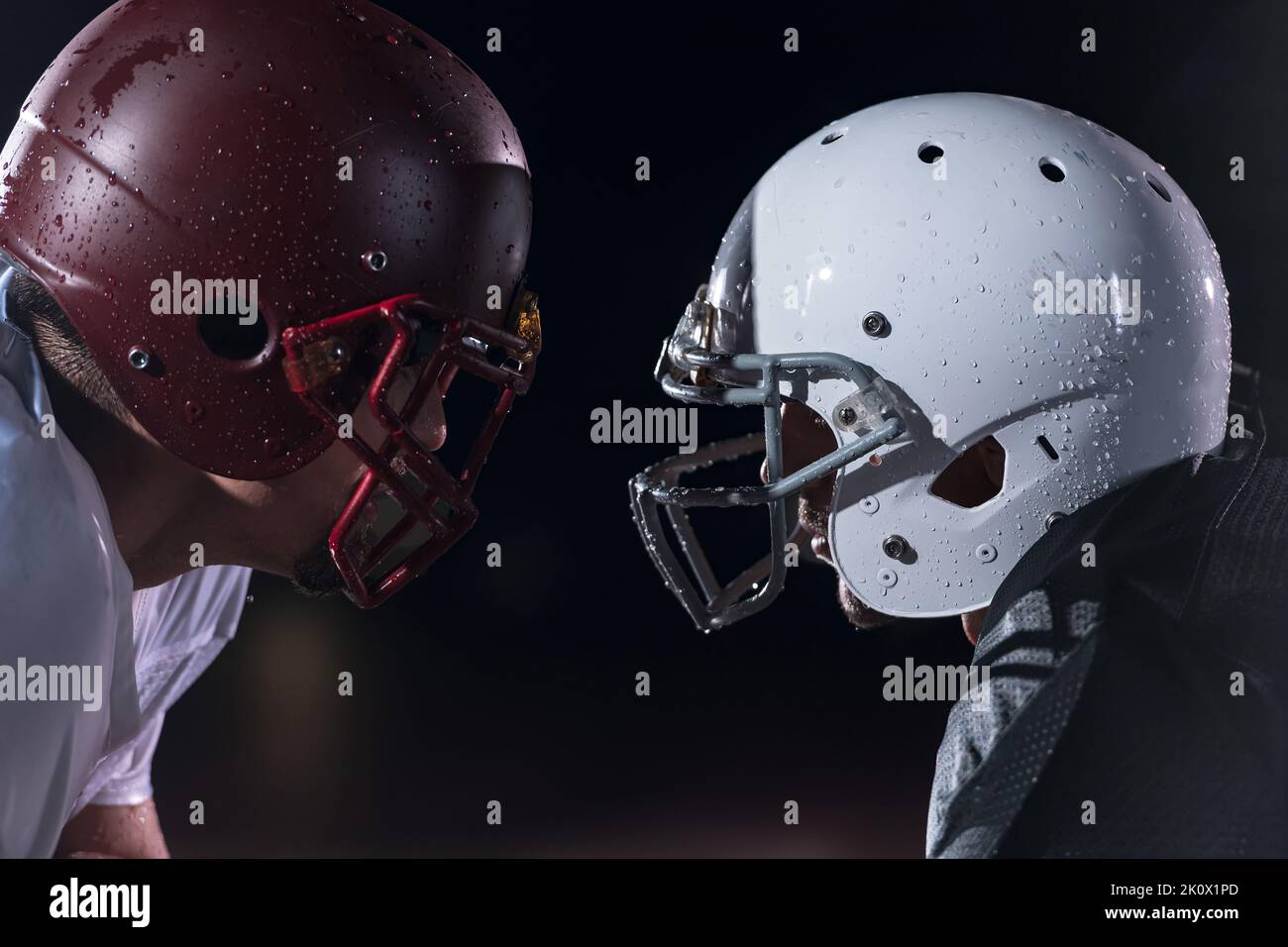 two american football players face to face in silhouette shadow on ...