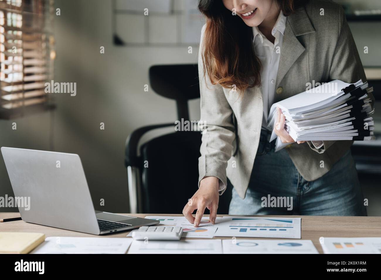 Businesswoman calculating bills, taxes and saving account balance ...