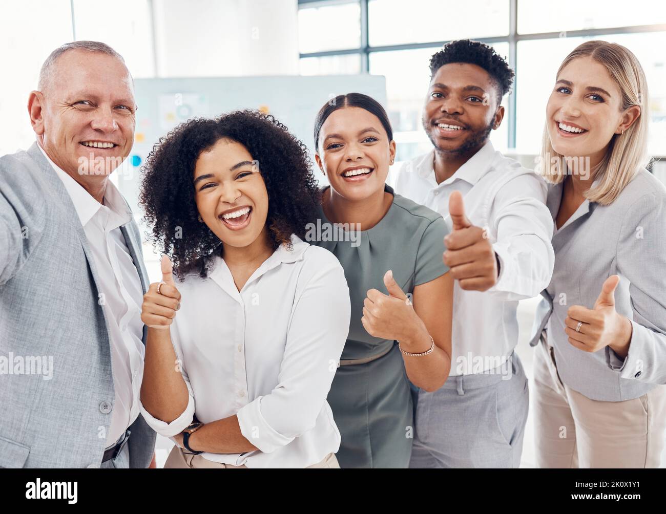 Happy business people or team with thumbs up at office for success, diversity and solidarity at ...