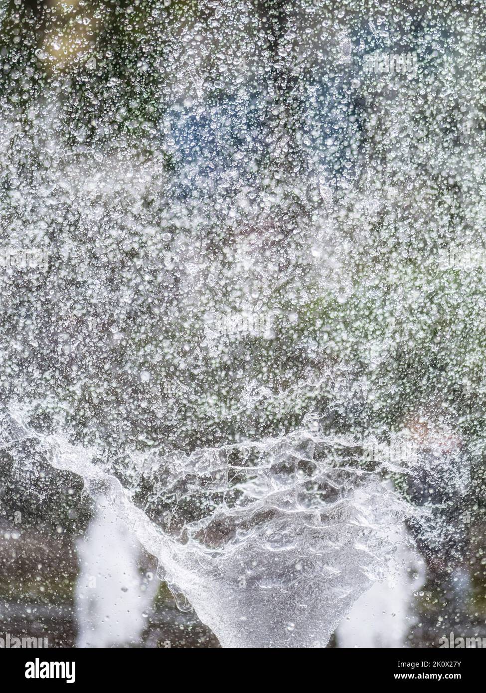 Water splashes from fountain on dark background. Natural texture of ...