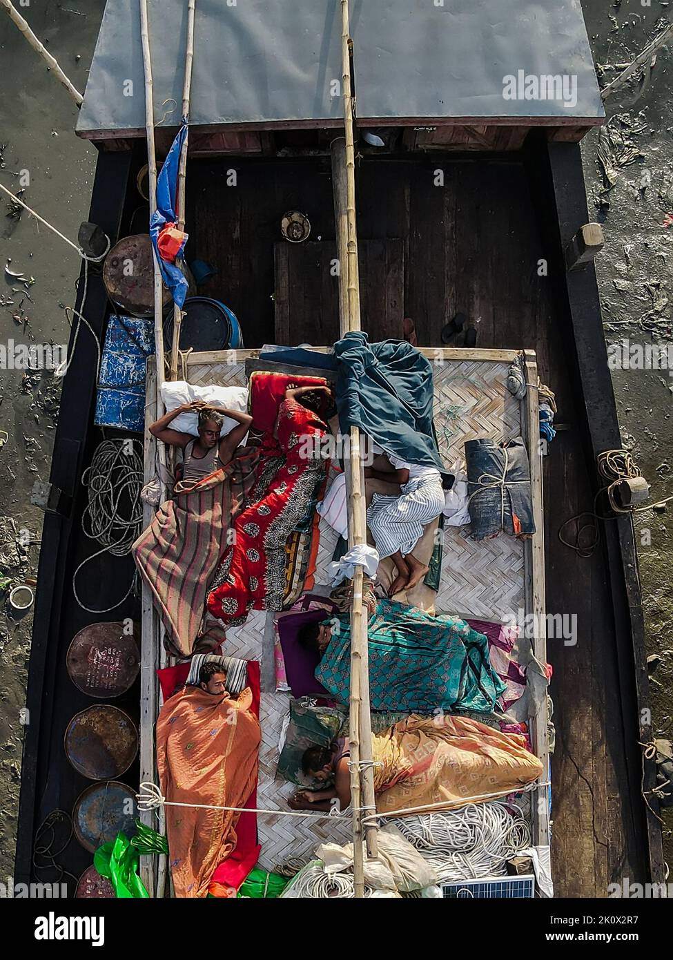Fishermen sleeping on fishing boats. They catch fish in the deep sea all night and come to the ...