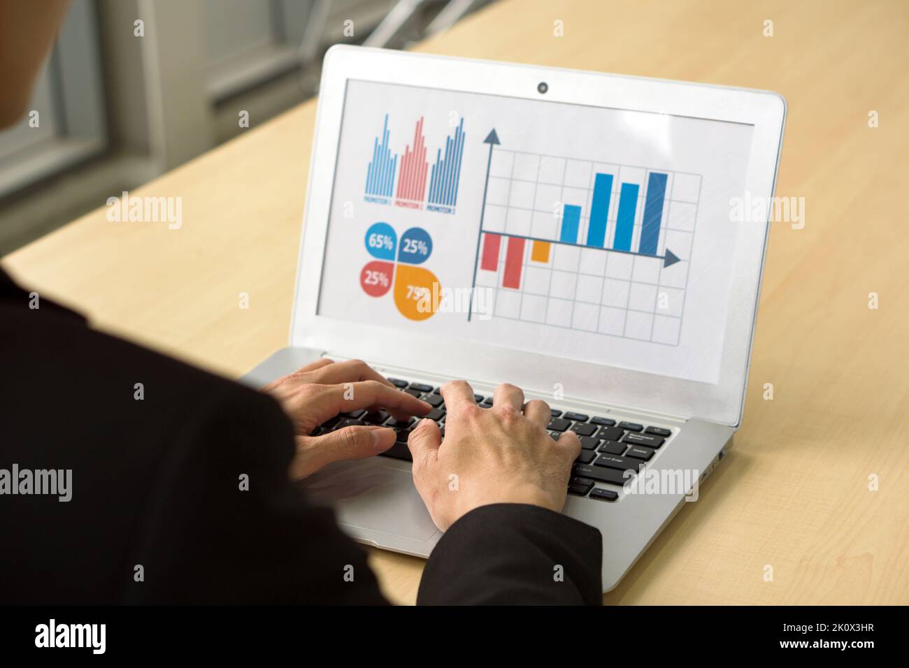 Back view of businessman in suit sit at desk in office typing on laptop ...