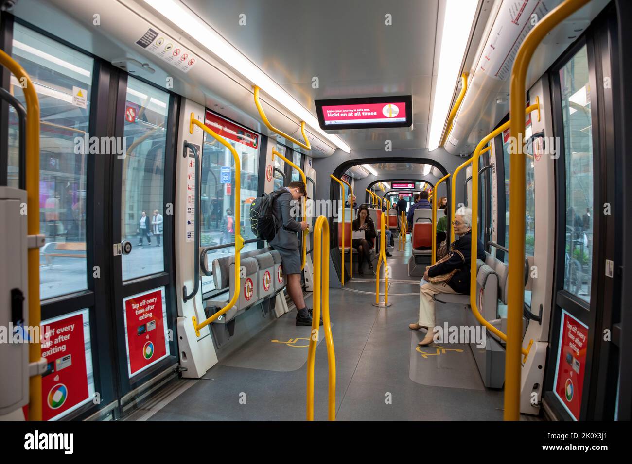 Interior of Sydney light rail train carriage with passengers and a ...