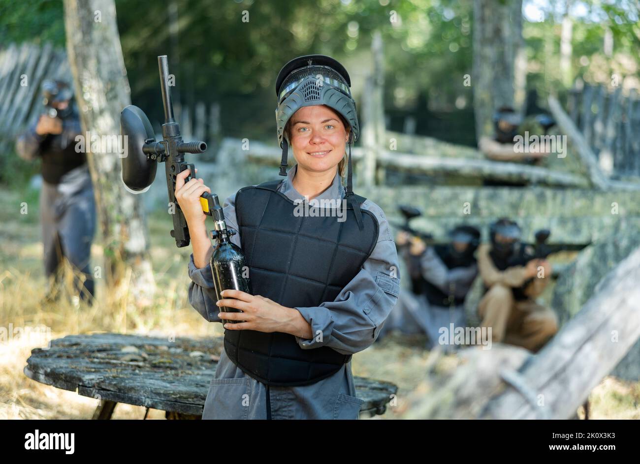 Portrait of cheerful woman paintball player Stock Photo - Alamy