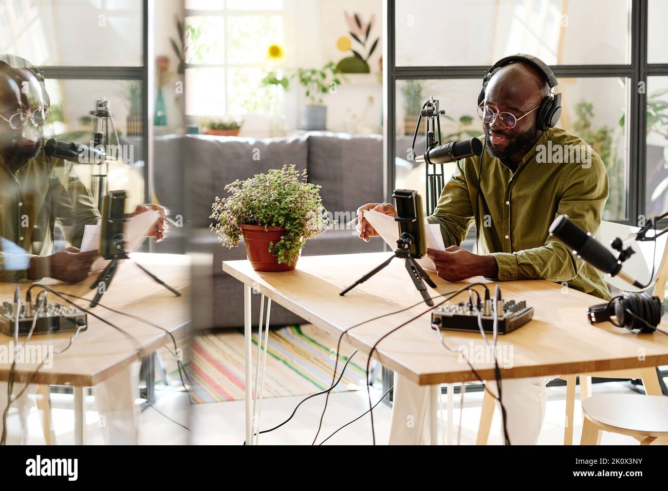 African American male blogger in headphones reading points of his ...
