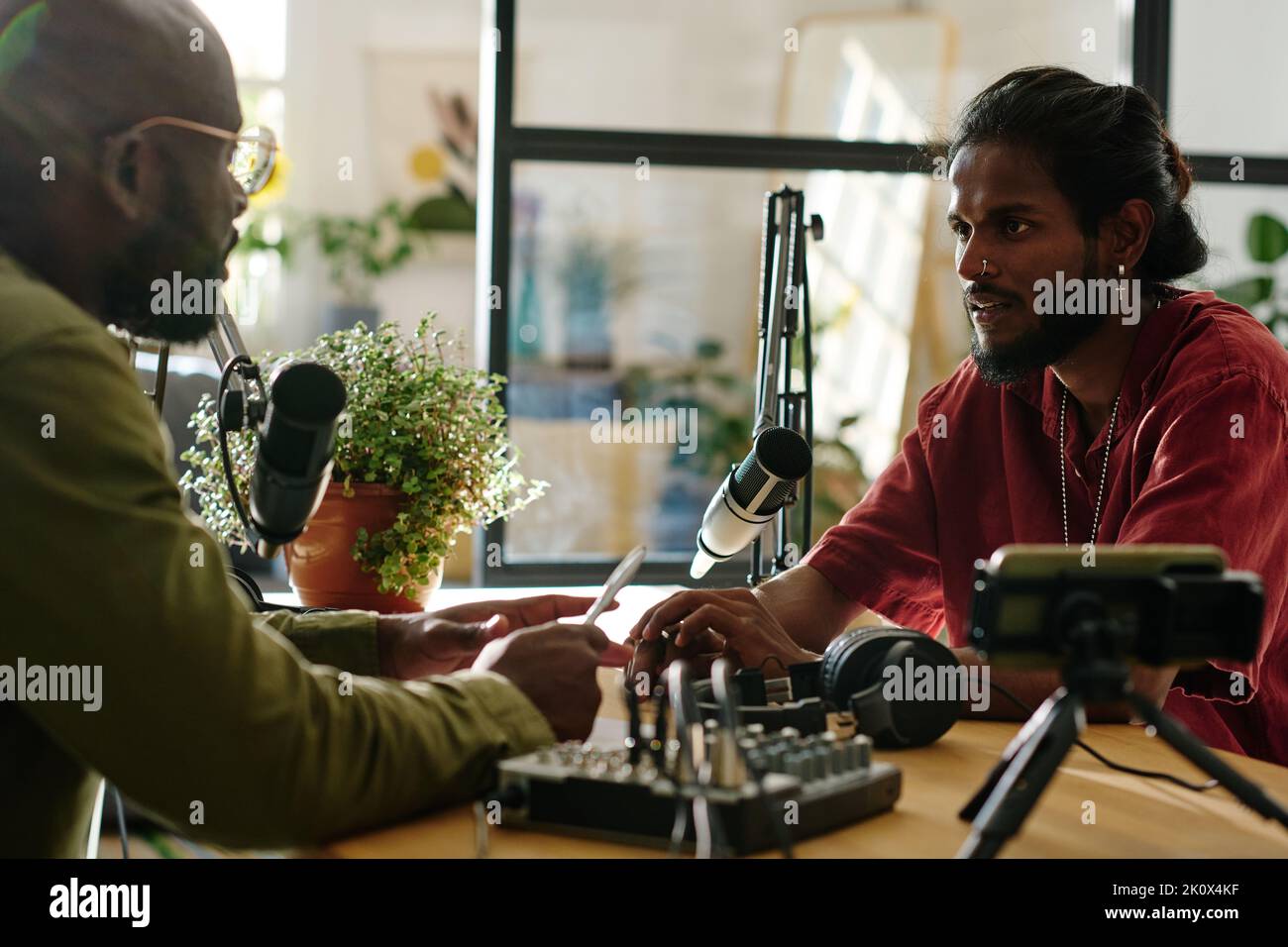 Young intercultural man looking at African American guy during ... Young intercultural man looking at African American guy during ...