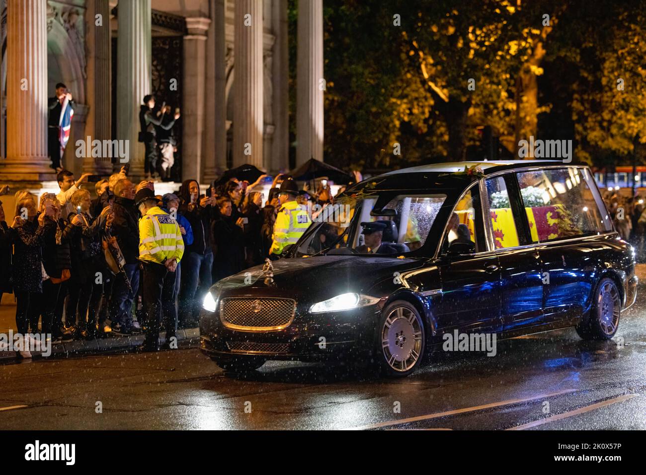 London, UK. 13th Sep, 2022. The state hearse of Queen Elizabeth II passes through the crowds at ...