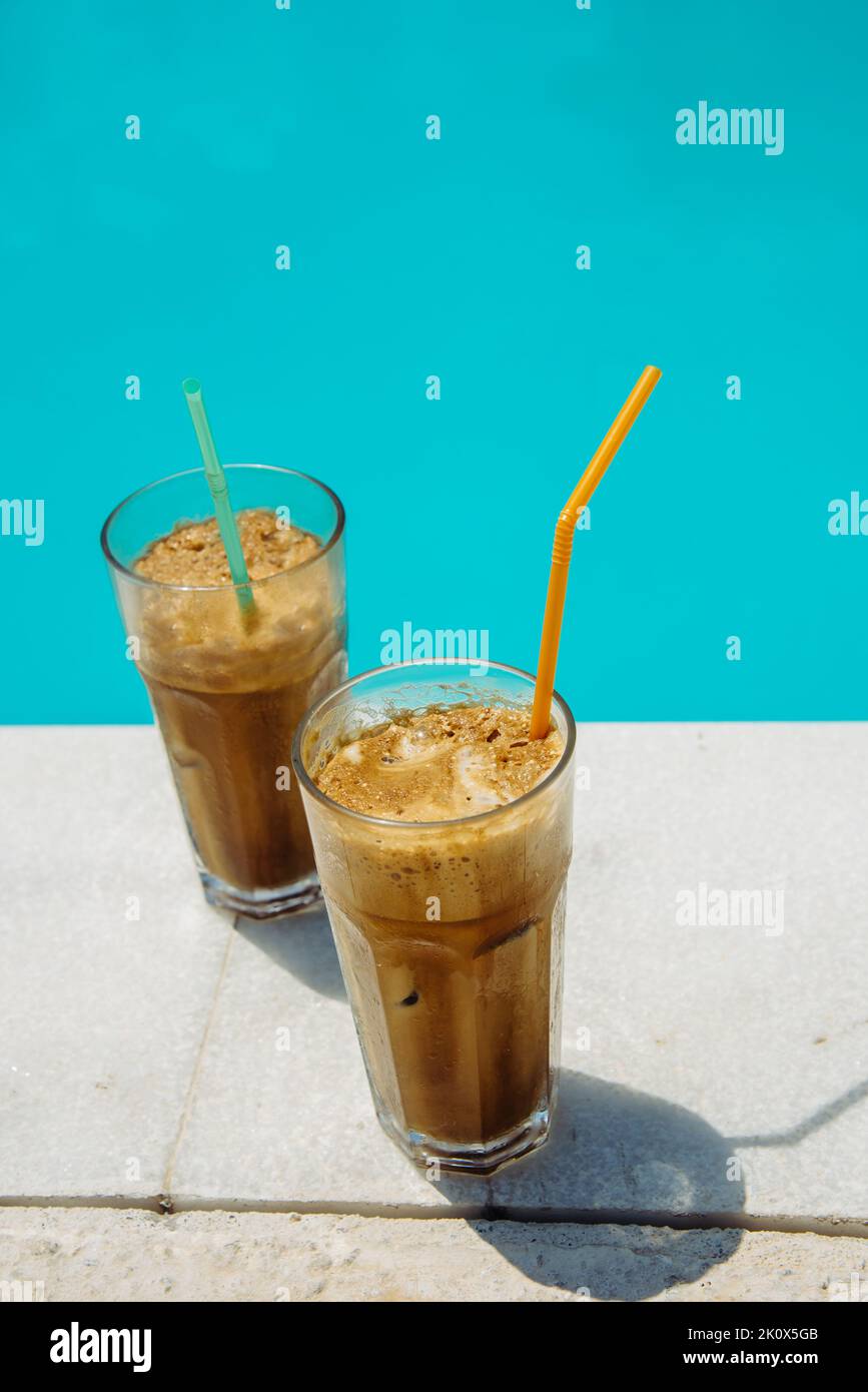 Summer holiday vacation with frappe refreshment by luxury poolside. Two ...