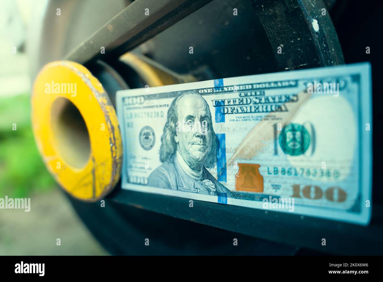 One hundred dollar bill close-up against the background of the engine ...