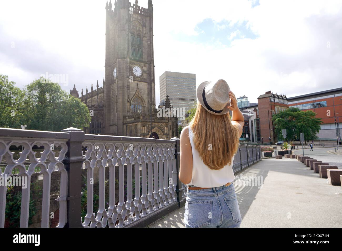 Tourism in Manchester, UK. Back view of beautiful woman visiting the ...