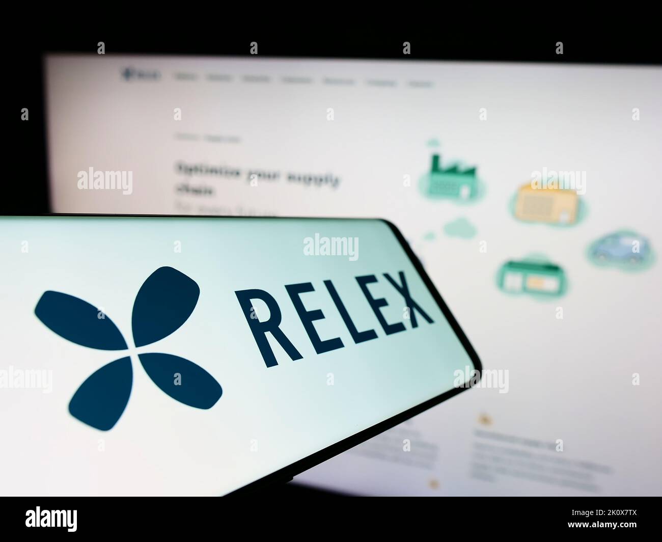 Smartphone with logo of Finnish software company RELEX Solutions on screen in front of business ...