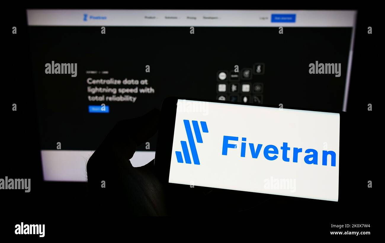 Person holding mobile phone with logo of American data software company ...