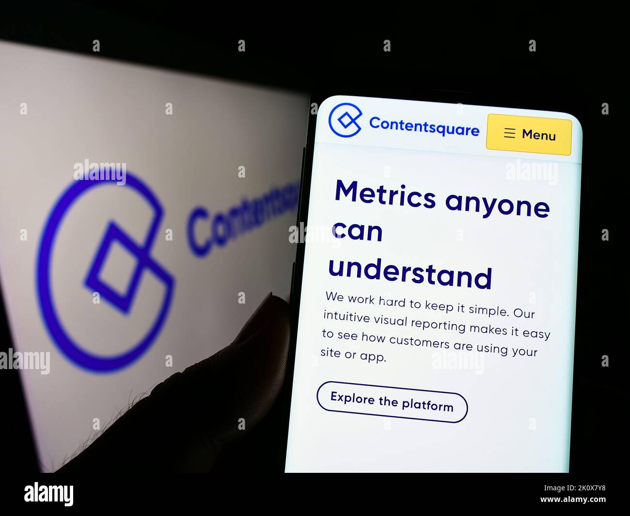 Person holding smartphone with webpage of analytics platform company ...