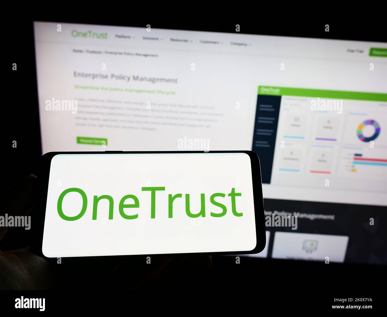 Person holding cellphone with logo of American software company ...