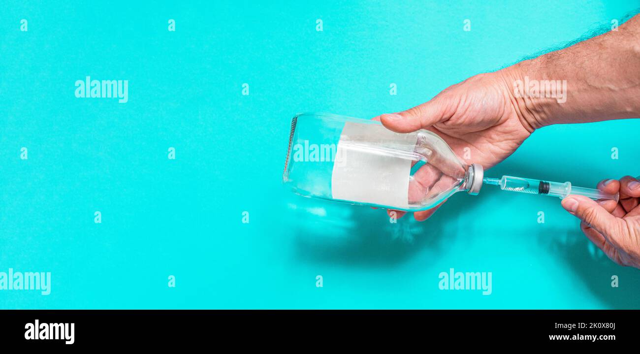 Syringe with vaccine on blue background from above Stock Photo - Alamy