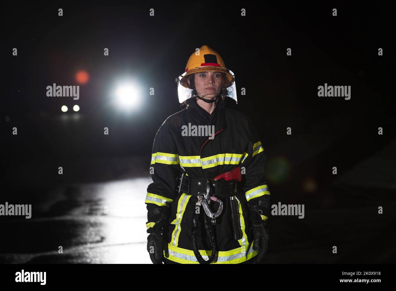 Portrait of a female firefighter standing and walking brave and ...