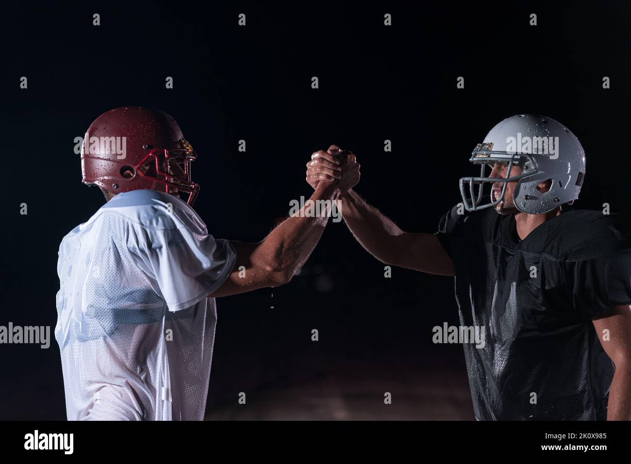 two american football players face to face in silhouette shadow on ...