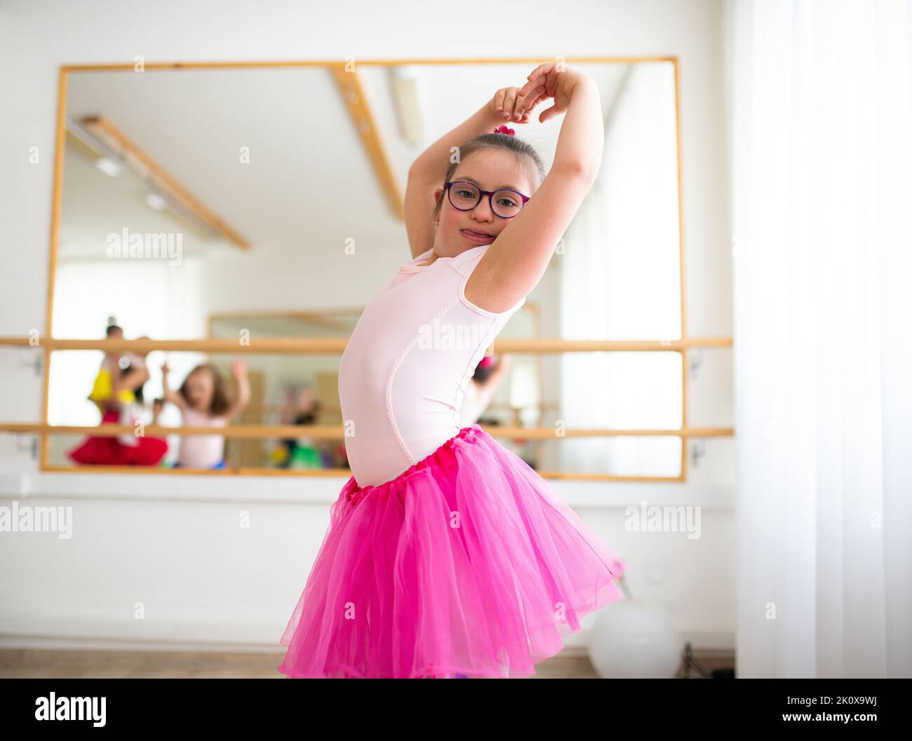 Little girl with down syndrome at ballet class in dance studio. Concept ...