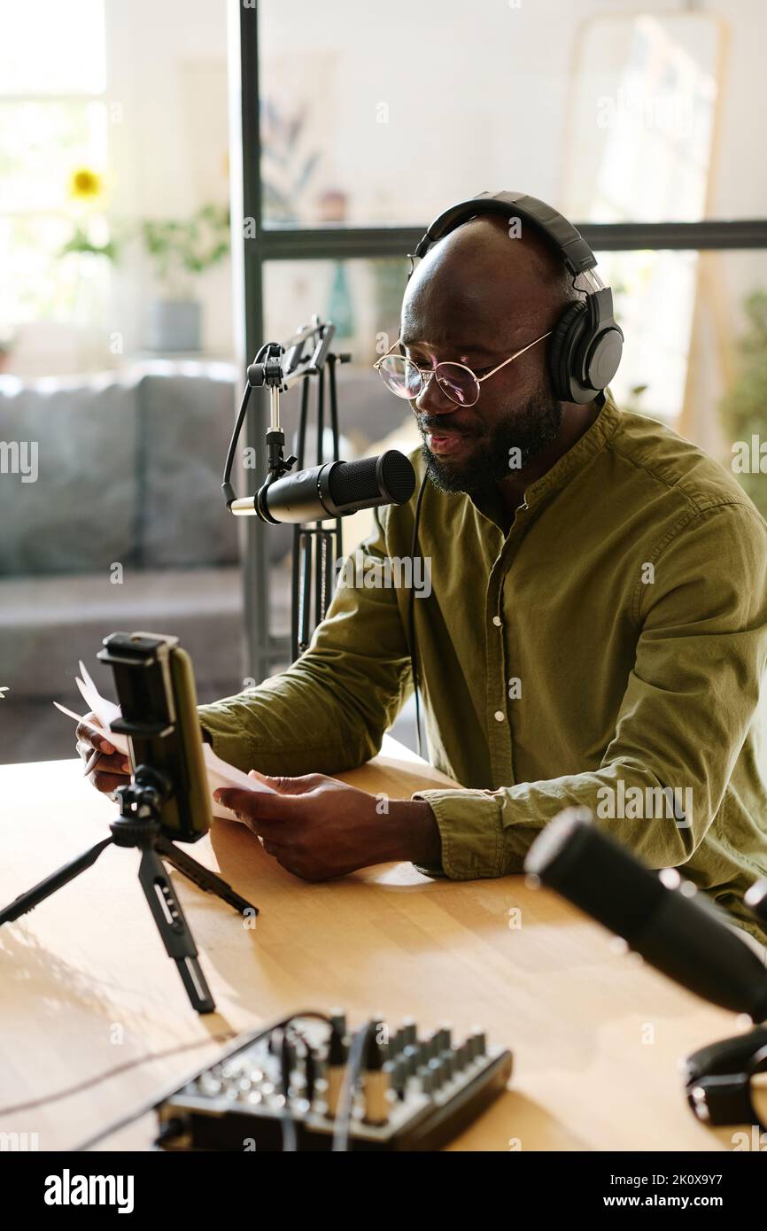 African man reading into microphone hi-res stock photography and images ...