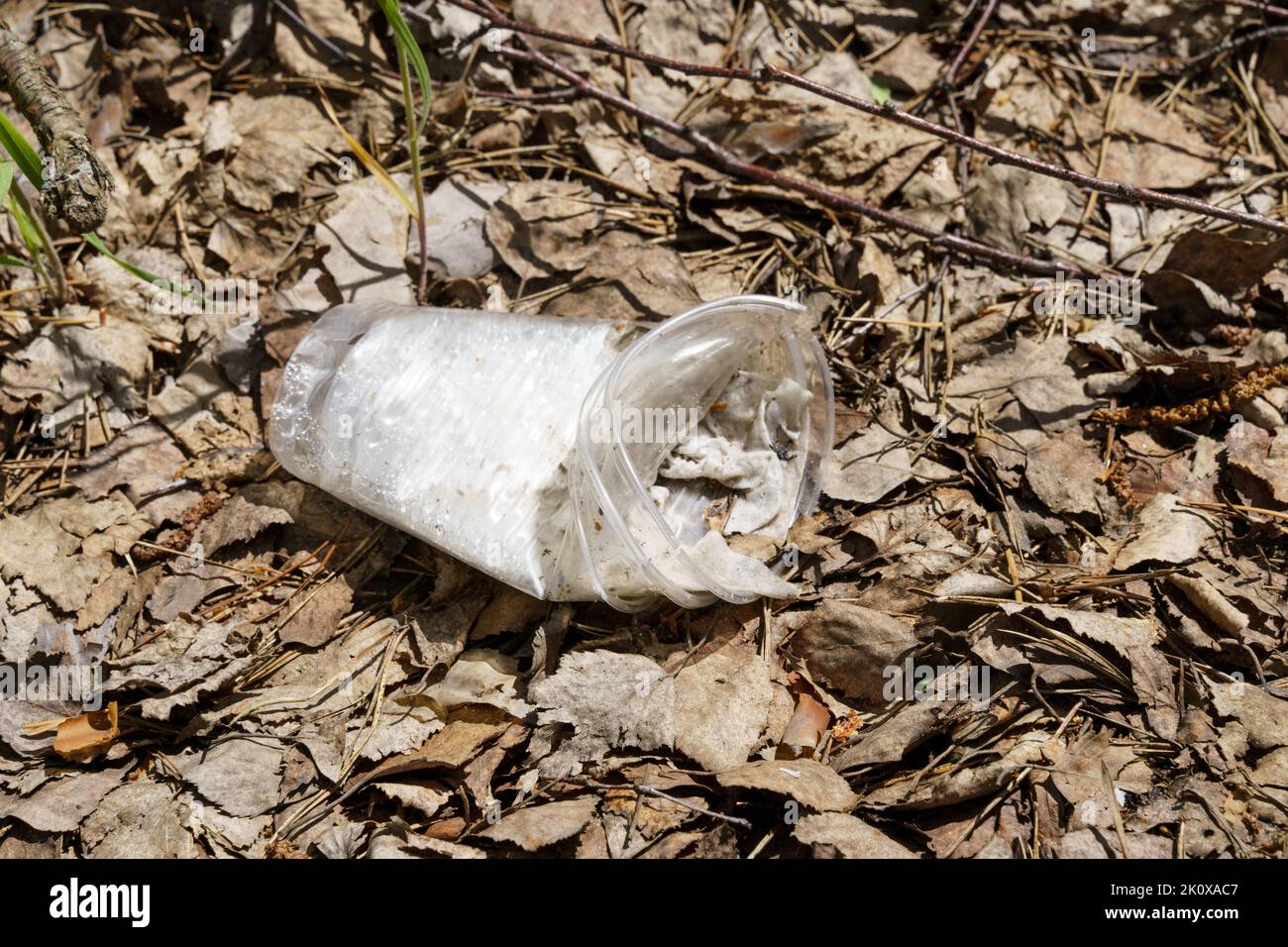 Ecology concept. A crumpled plastic cup lies on the ground Stock Photo ...