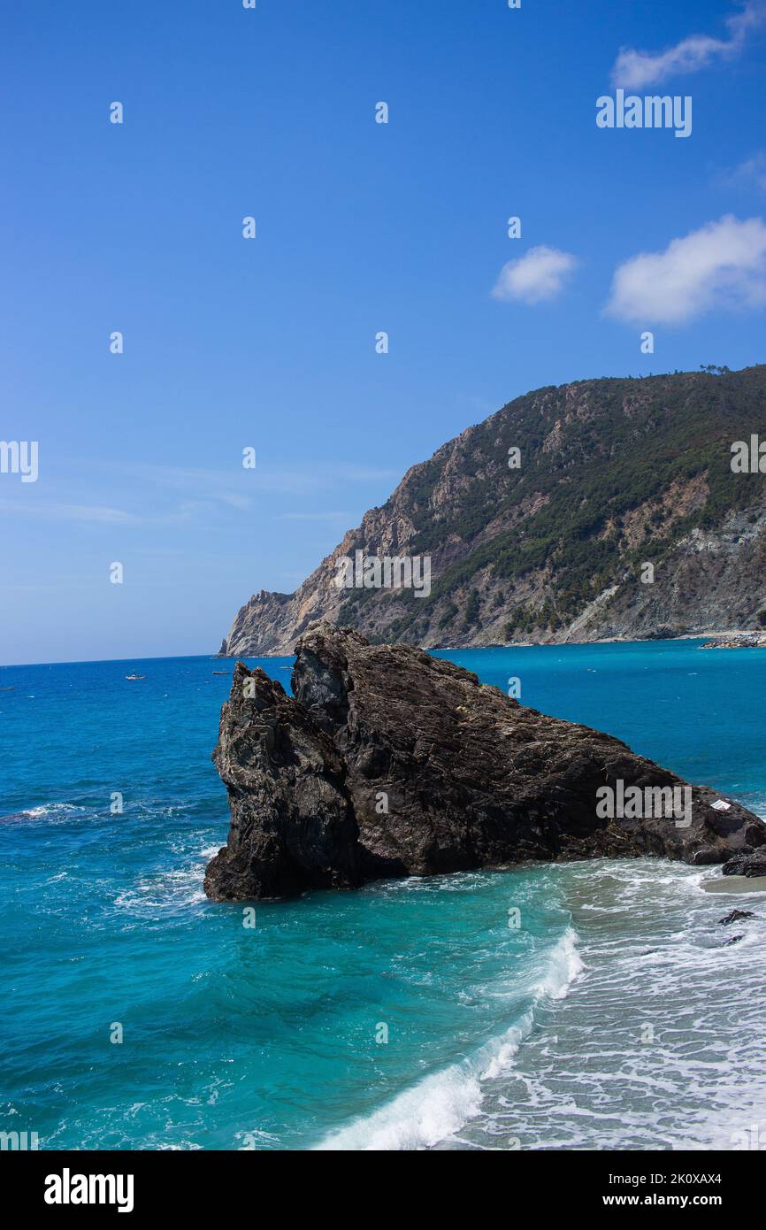 A vertical of a big rock, sea stack captured in the sea near the coast ...