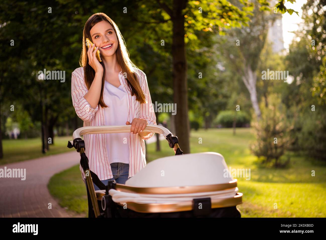 Photo of charming pretty lady mommy walk spring with baby carriage ...