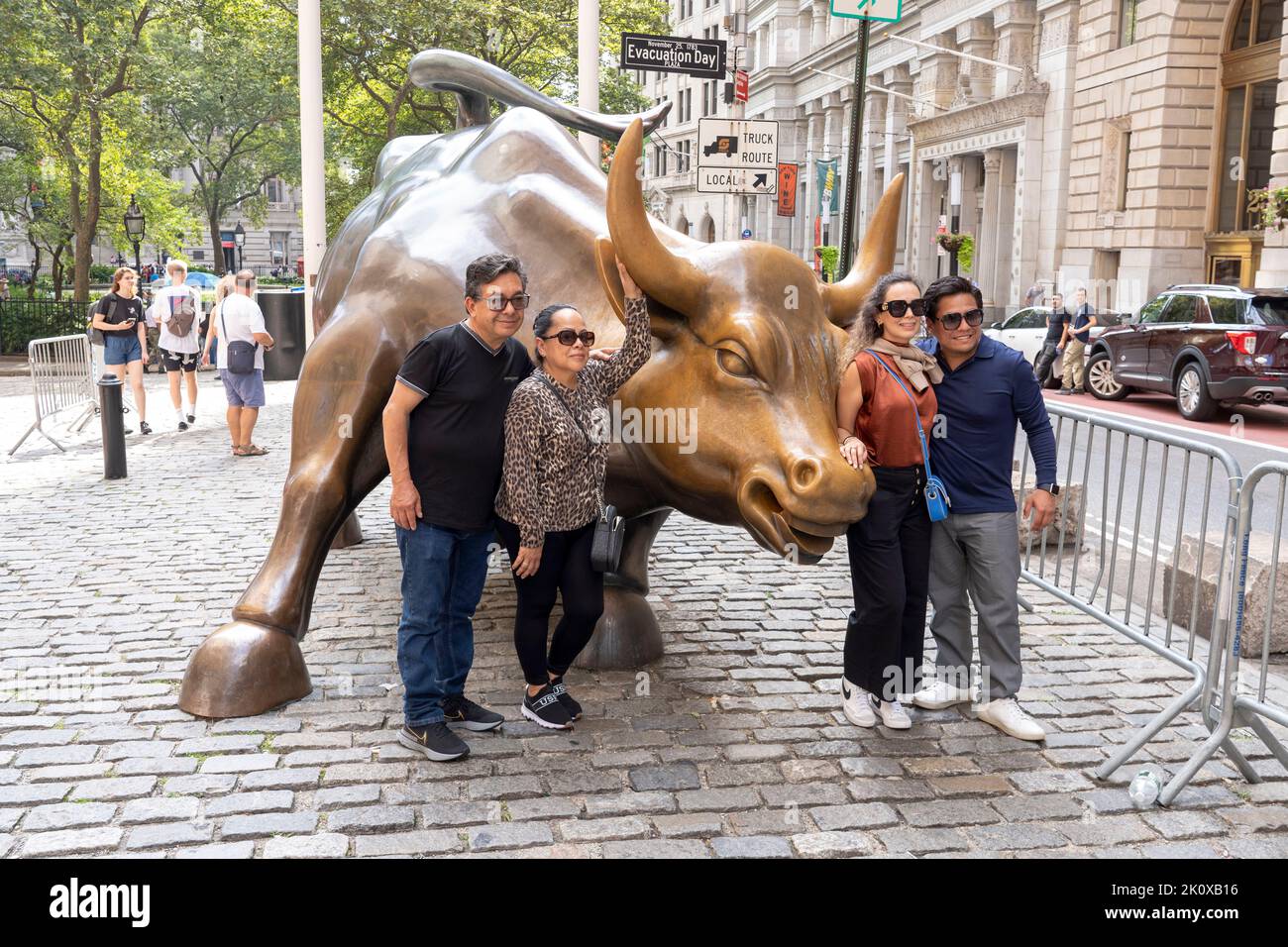 NEW YORK, NEW YORK - SEPTEMBER 13: People pose with the Charging Bull (Wall Street Bull) in the ...
