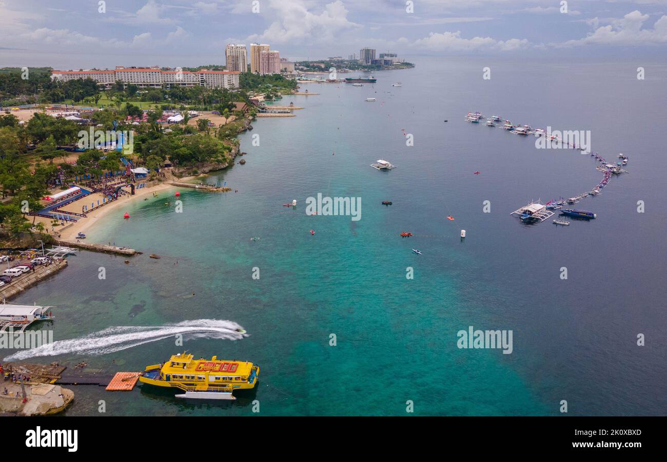 A bird's eye view of hotels on coastline of Cebu, Philippines against a ...