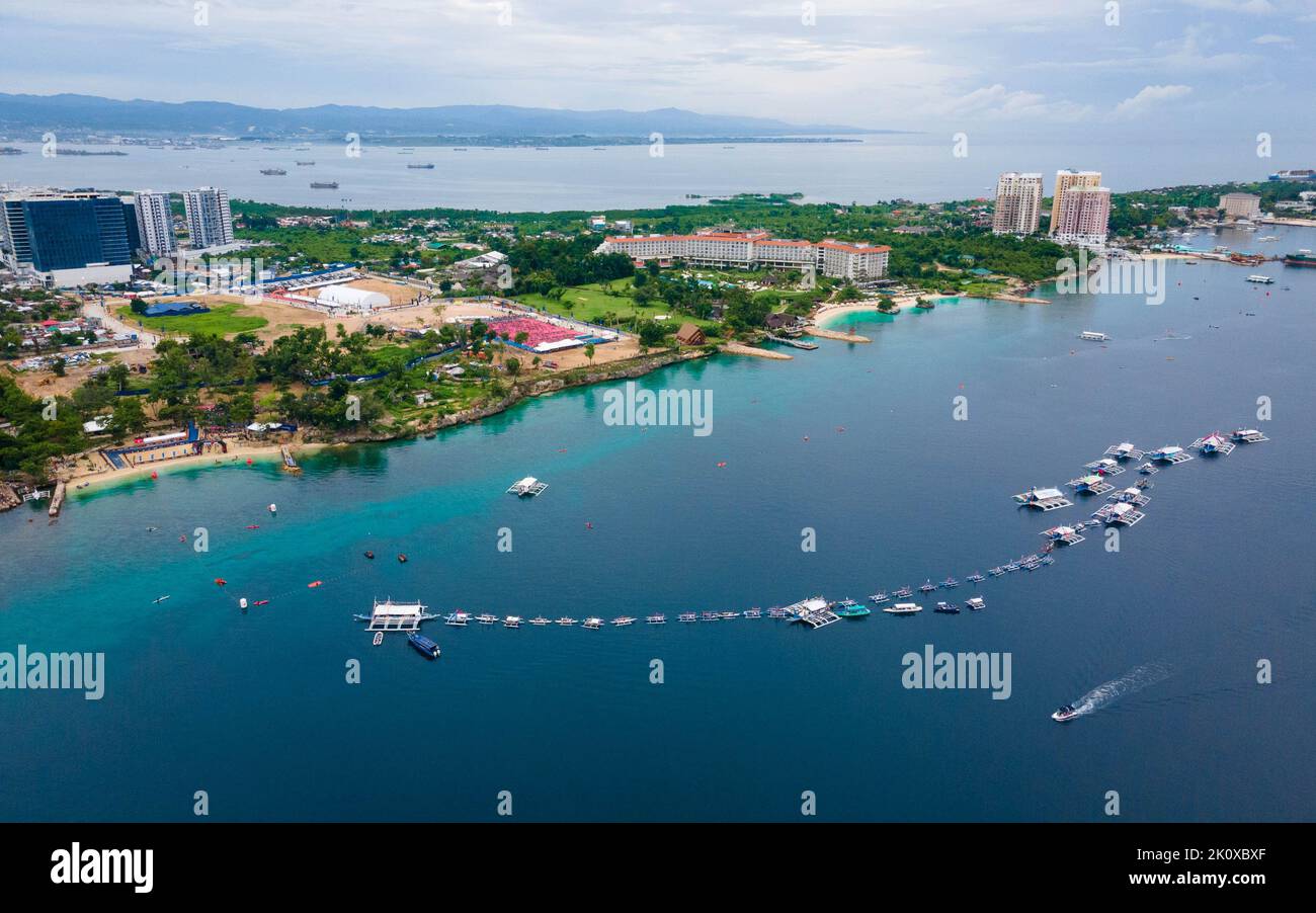 A bird's eye view of hotels on coastline of Cebu, Philippines against a ...