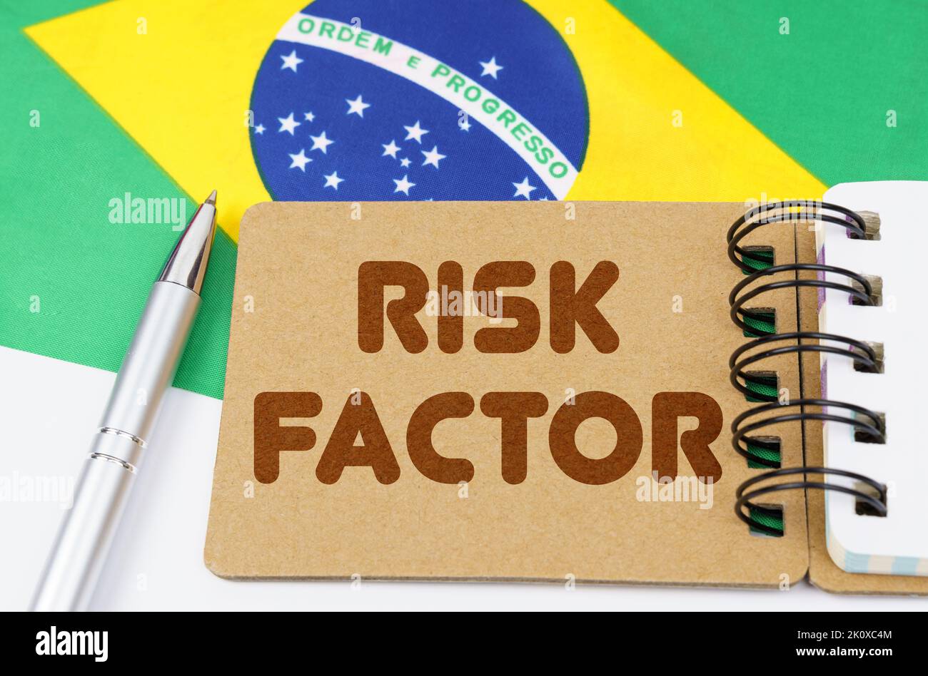 National economy concept. On the flag of Brazil lies a notebook with ...