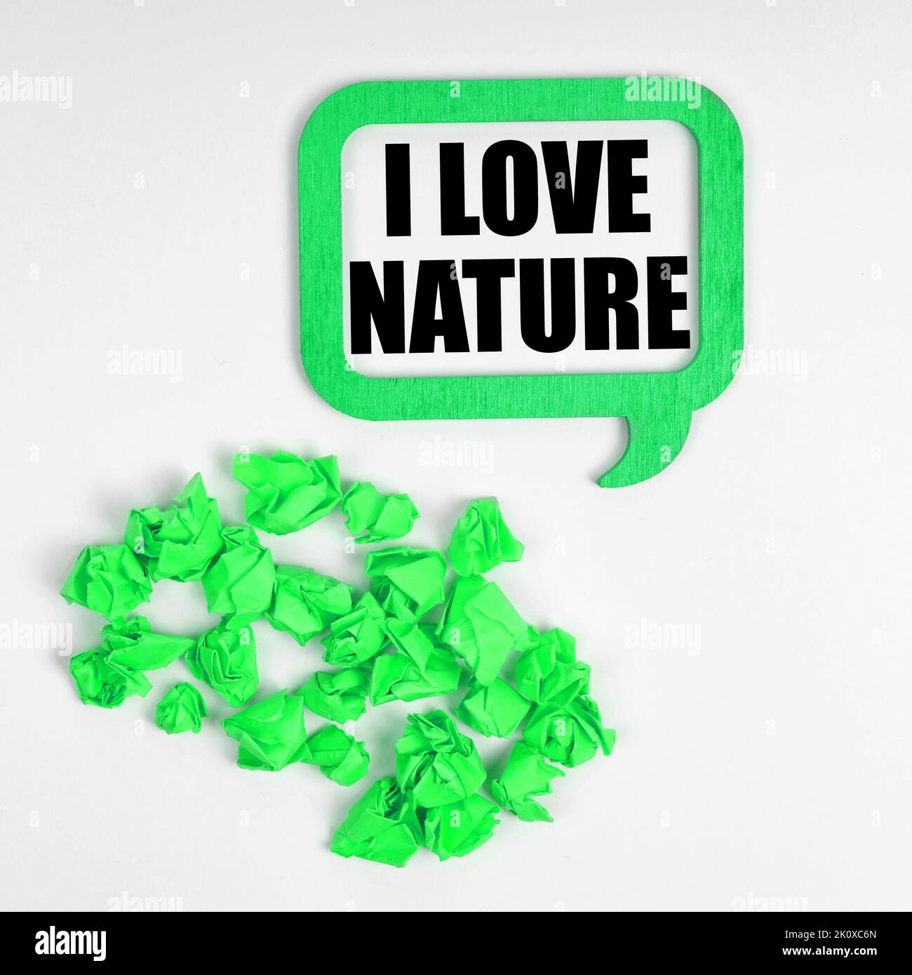 Ecology concept. On a white background, green crumpled pieces of paper ...