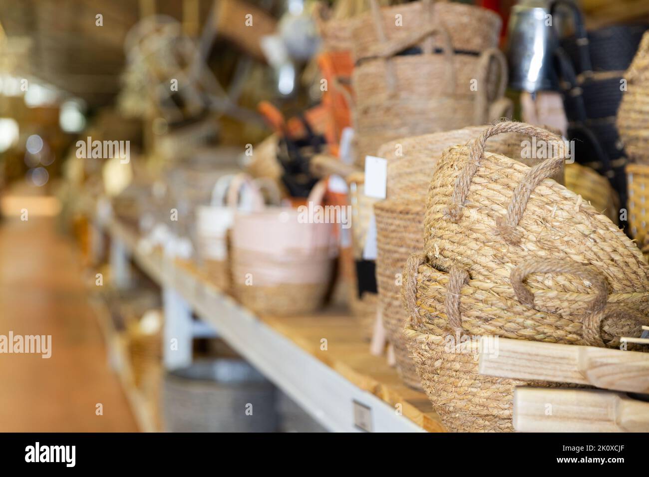 Wicker baskets and other handmade items on store shelves close up Stock ...